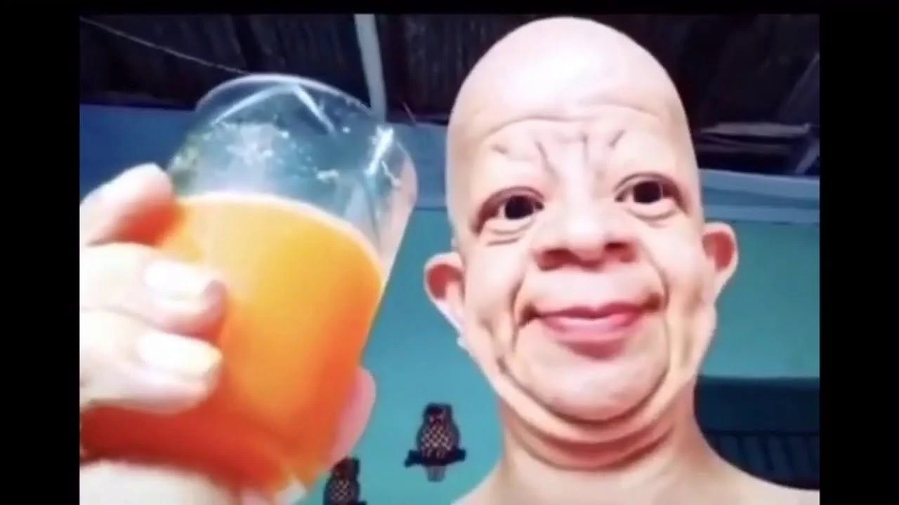 Bald wrinkly man drinking orange juice. | Fandom