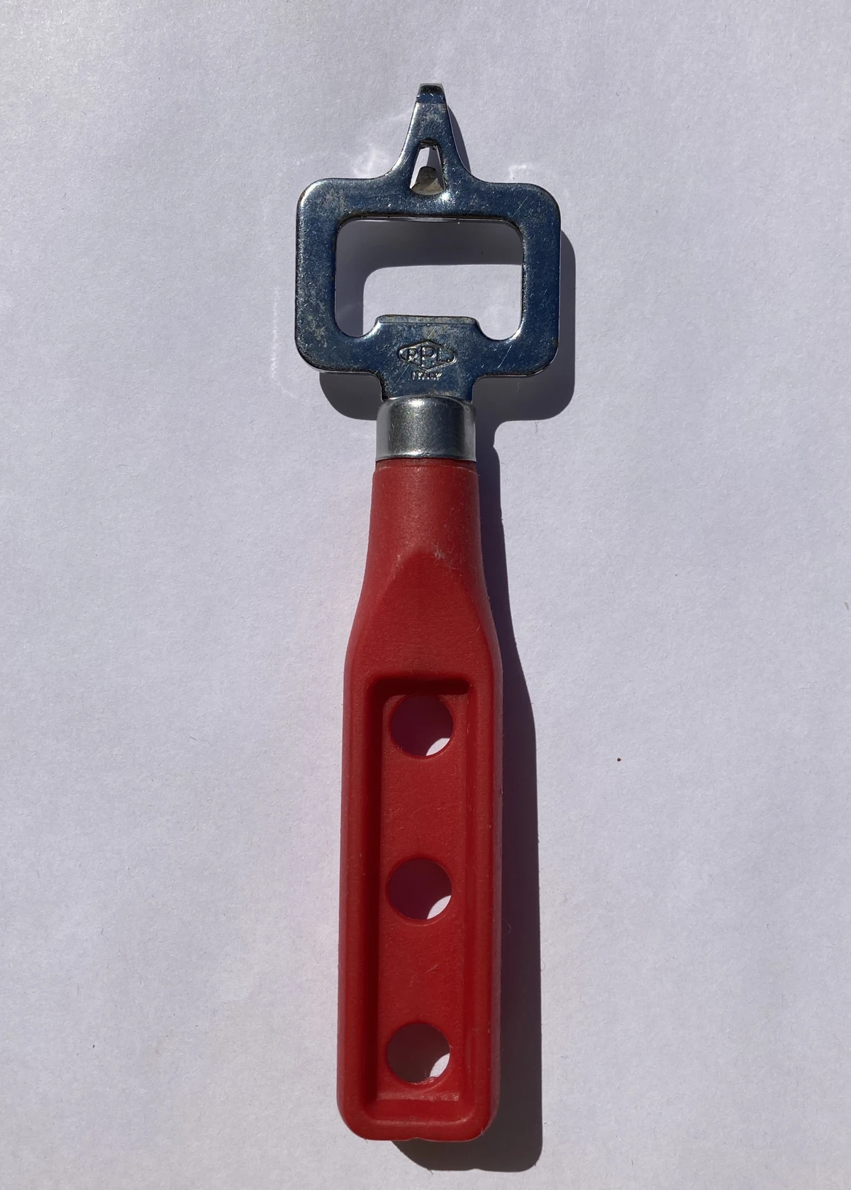 P.P.L. Italy red plastic bottle opener with three holes in its handle ...
