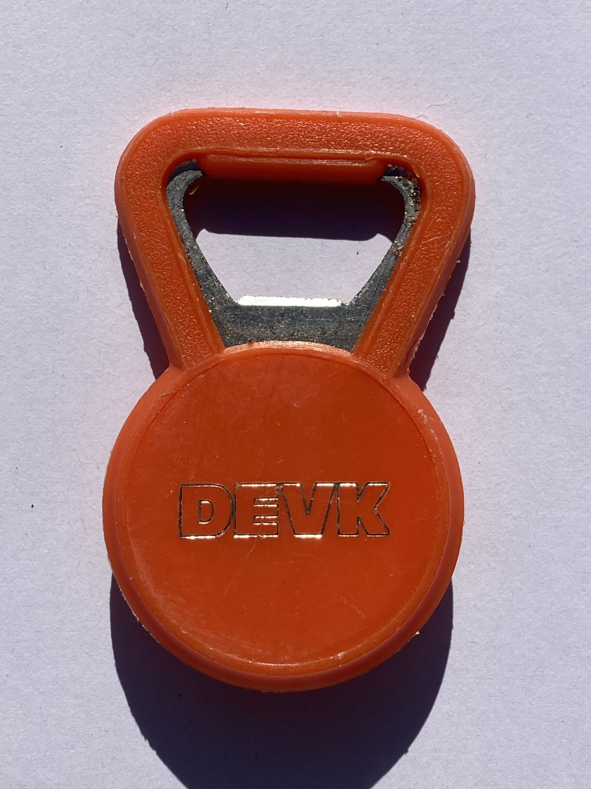 DEVK round orange plastic bottle opener | Bottle Openers Wiki | Fandom